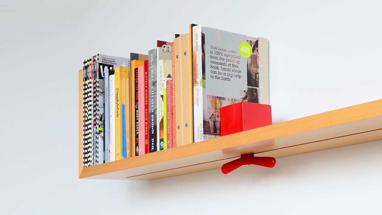 Wall-Mounted Shelf Prevents Toppling Books With Sliding Lock - Fast Company