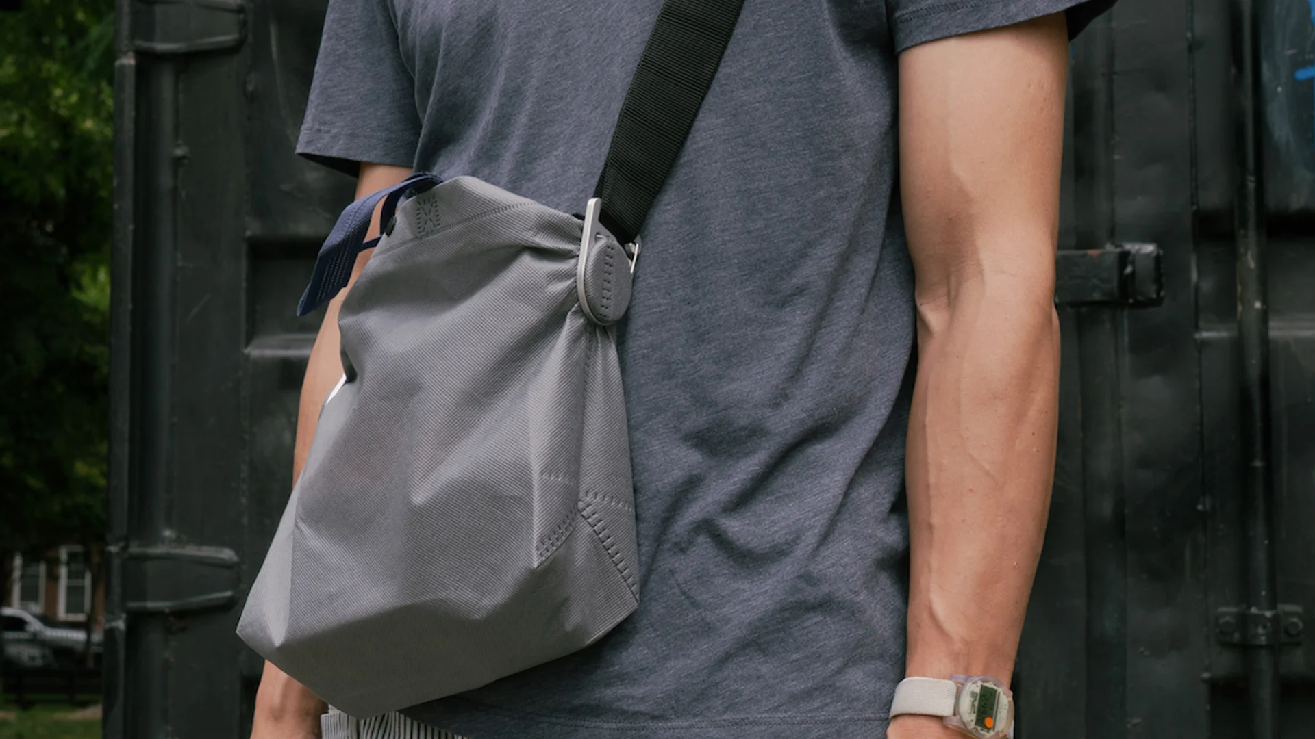 This genius clamp instantly transforms your tote into a crossbody bag ...