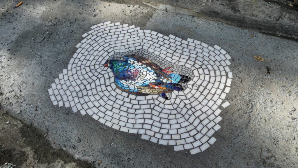 This artist quietly fixed a pothole with a mosaic of Trump's face ...