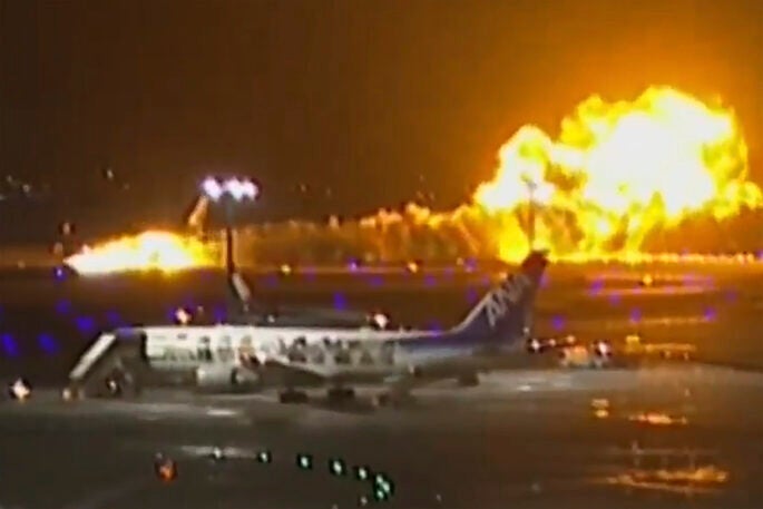 Japan Airlines fire today: photos show flight JAL-516, Haneda Airport